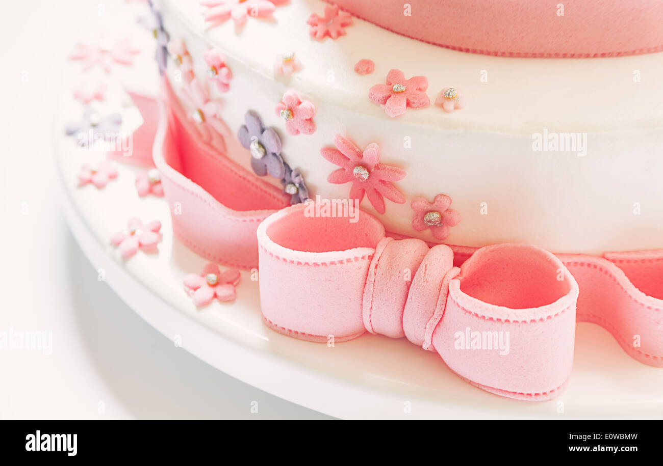 Details of a birthday cake, view on ribbon decoration Stock Photo - Alamy