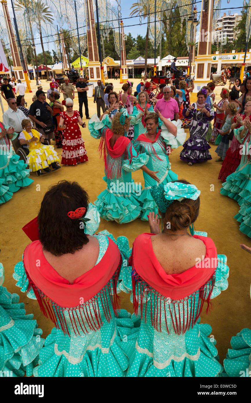 Women wearing gypsy dresses perform traditional Andalusian dances at ...
