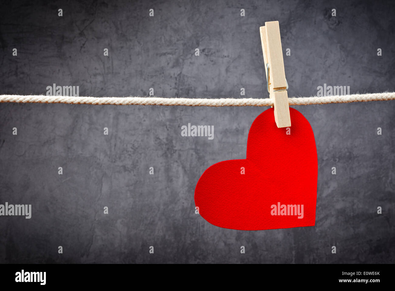 Heart shaped Valentine's Day card with copy space attached to a rope ...