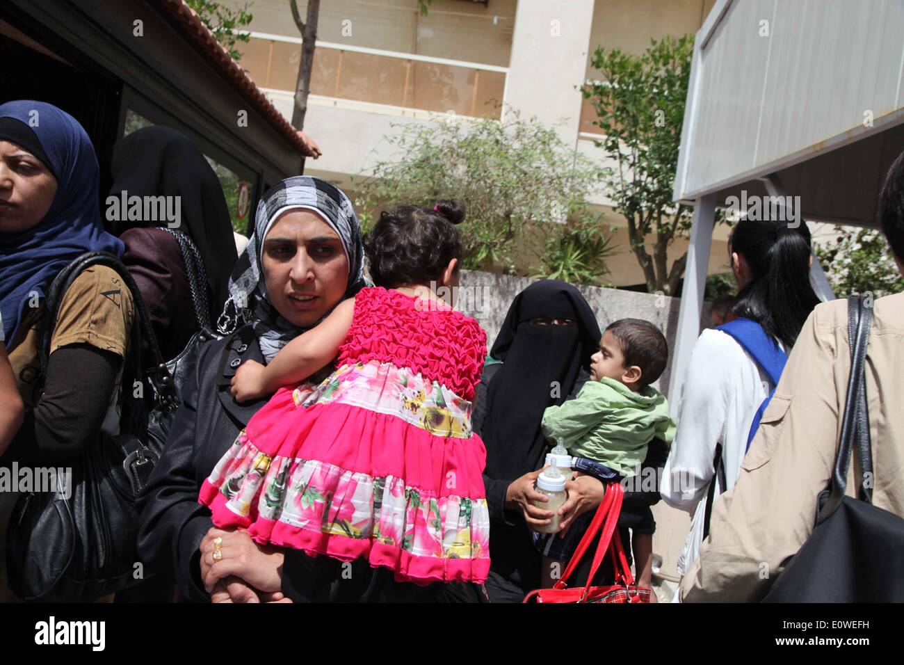 Beirut, Lebanon. 19th May, 2014. A Syrian mother holds her child as she ...
