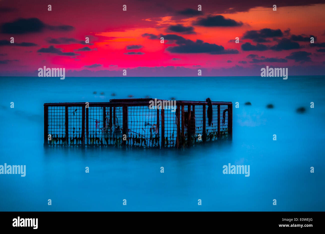 Seascape and Empty Cage at Colorful Cloudy Sunset Stock Photo - Alamy