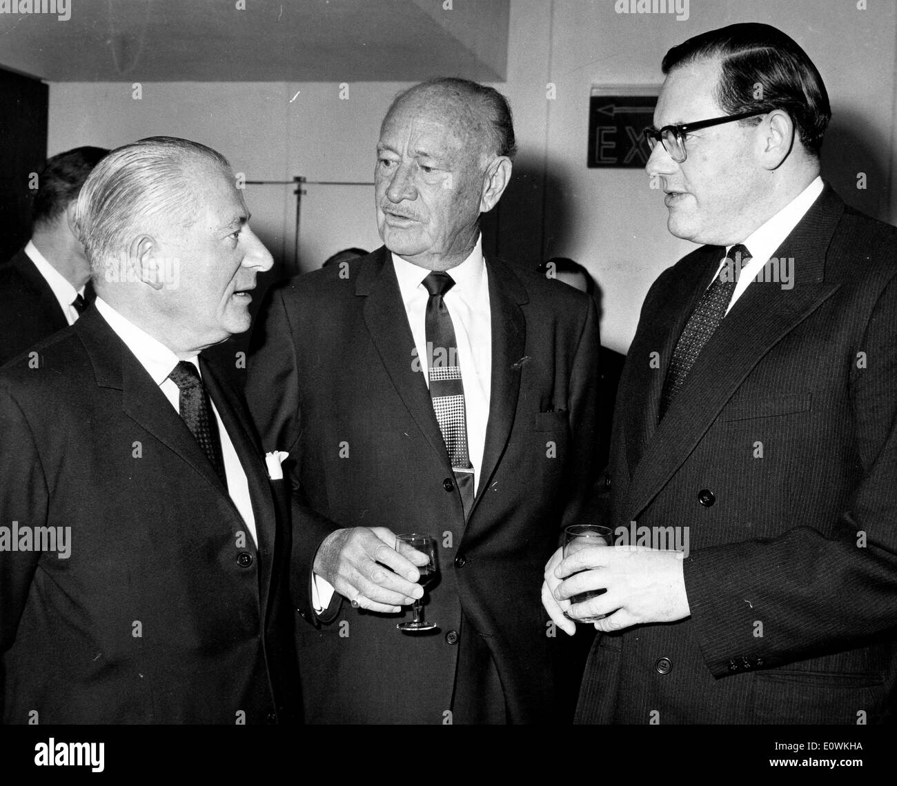 Conrad Hilton talks with others at a Hilton Hotel opening Stock Photo ...