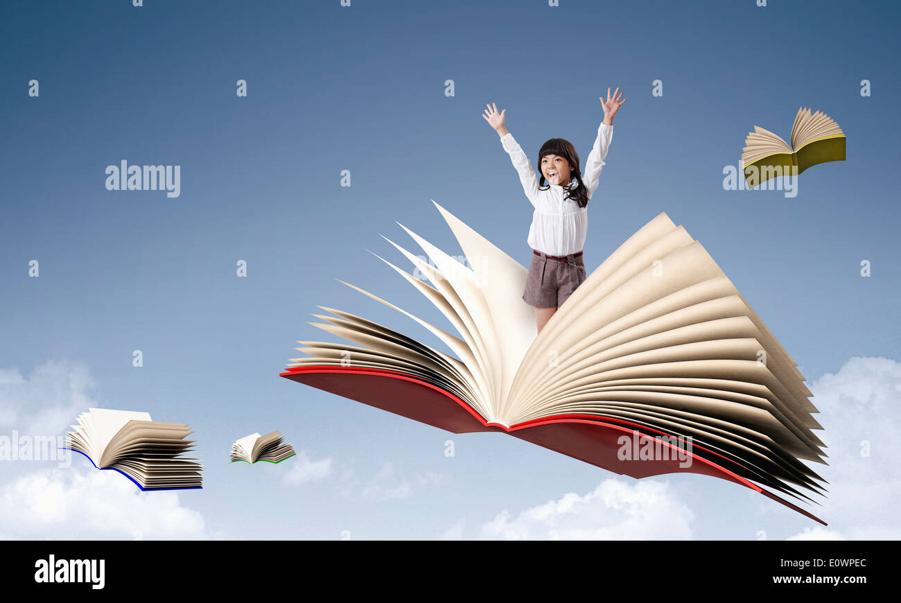a girl flying on a book Stock Photo - Alamy