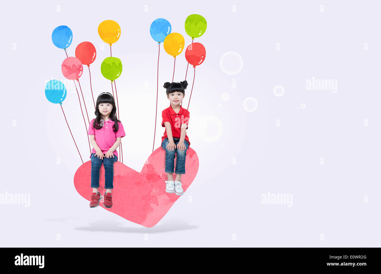 two girls holding balloons Stock Photo - Alamy