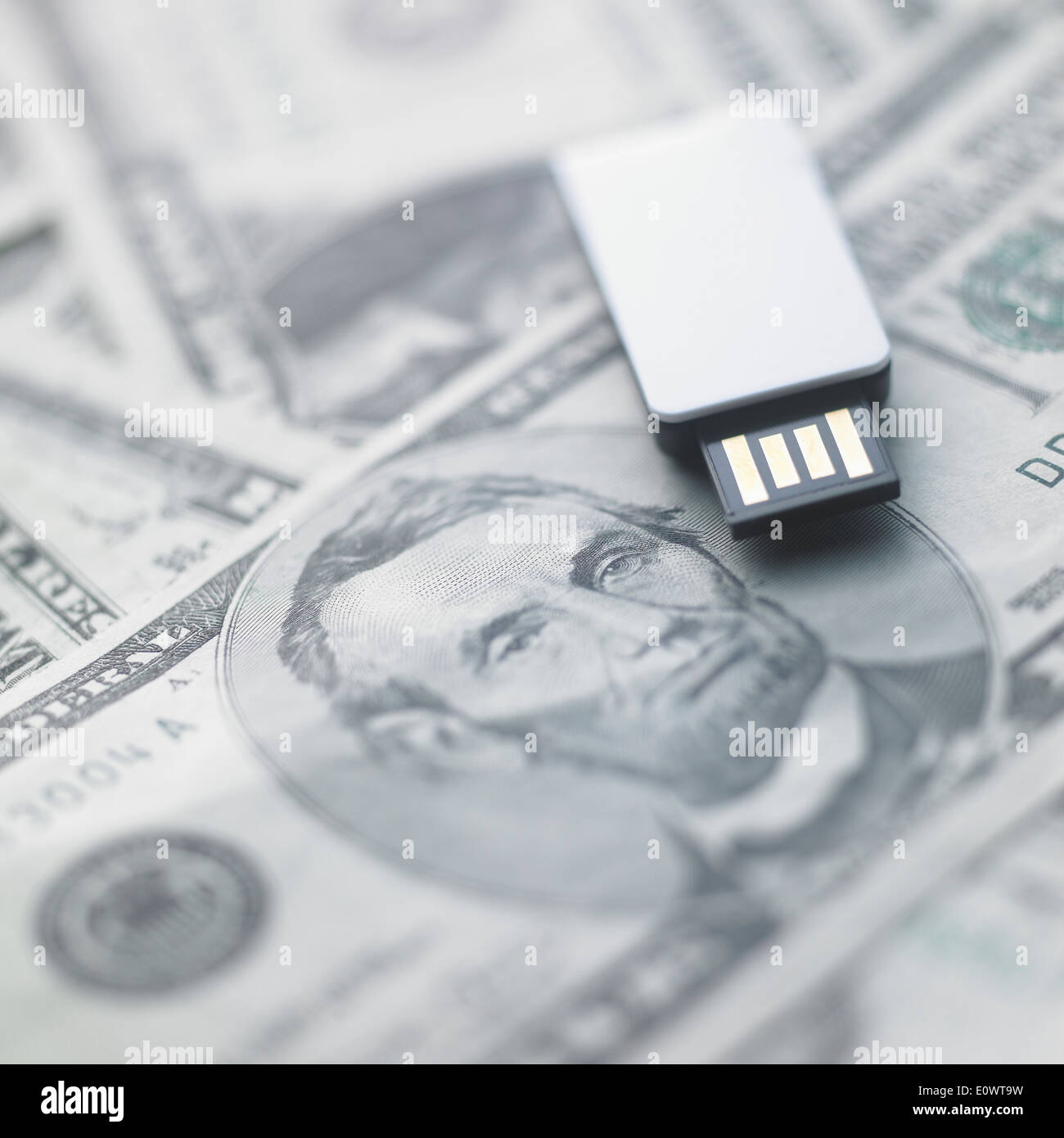 a pile of dollar bills under a usb memory card Stock Photo - Alamy