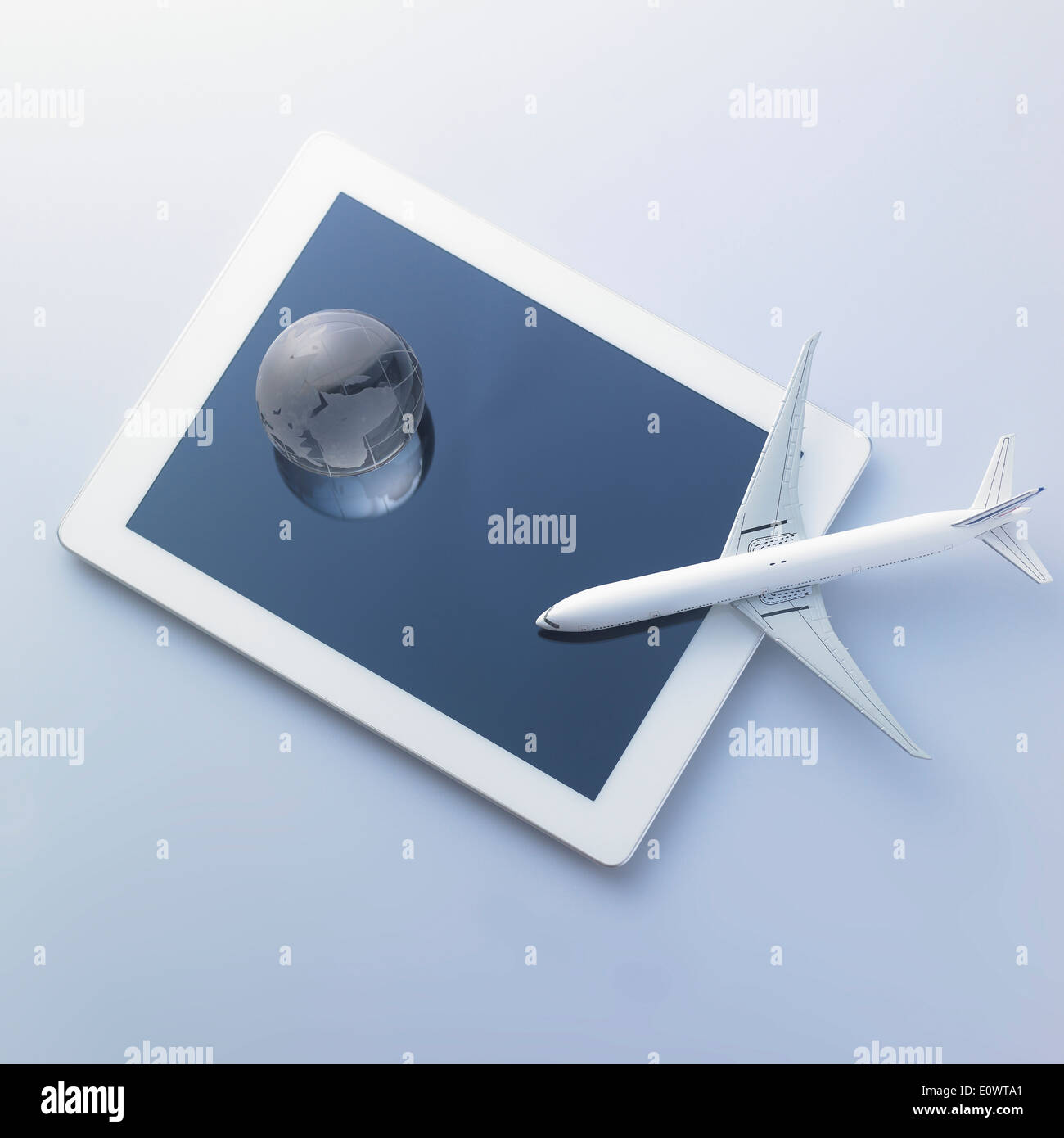a plane and a glass ball on a tablet Stock Photo - Alamy