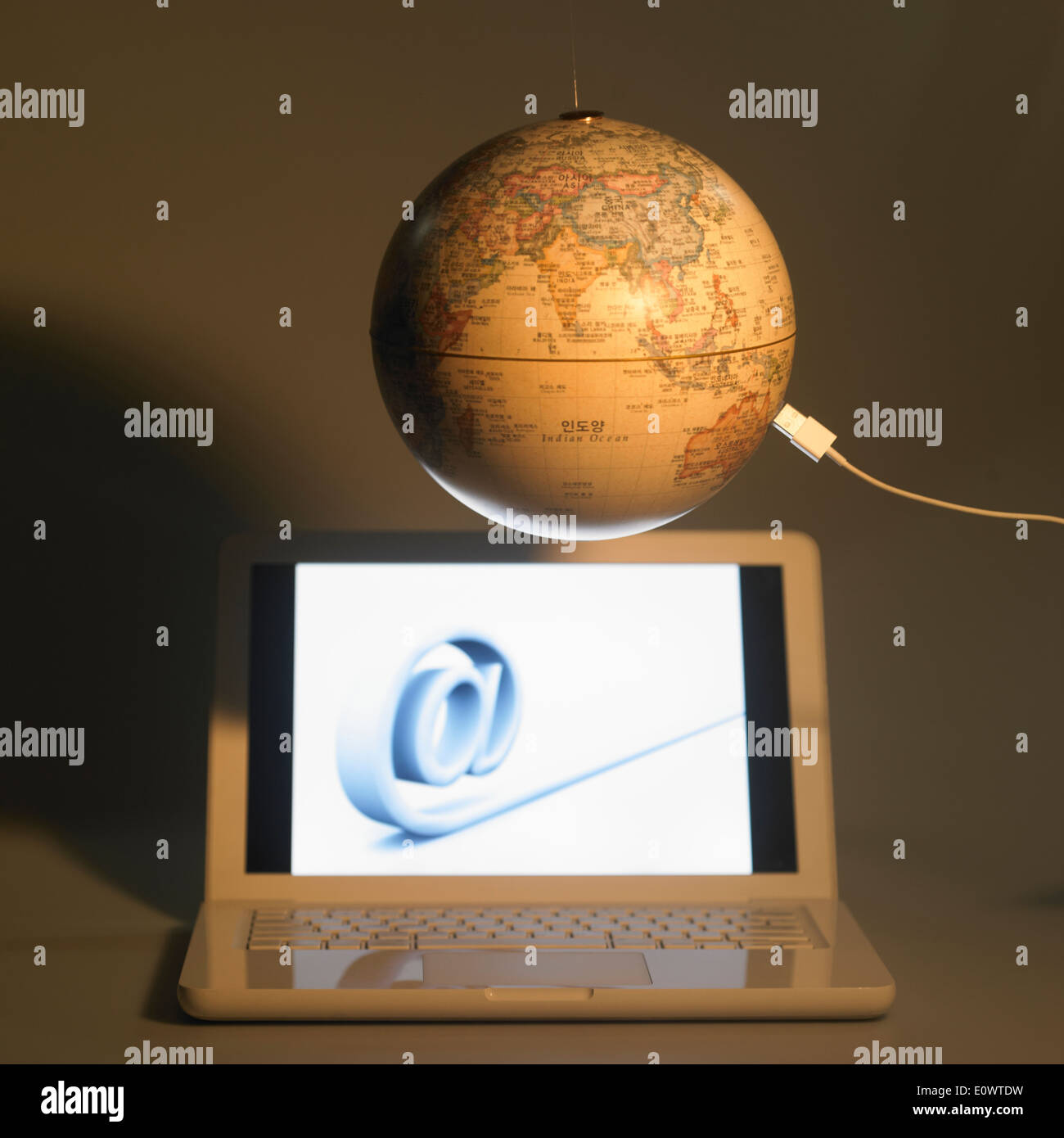 the globe on top of a laptop Stock Photo - Alamy