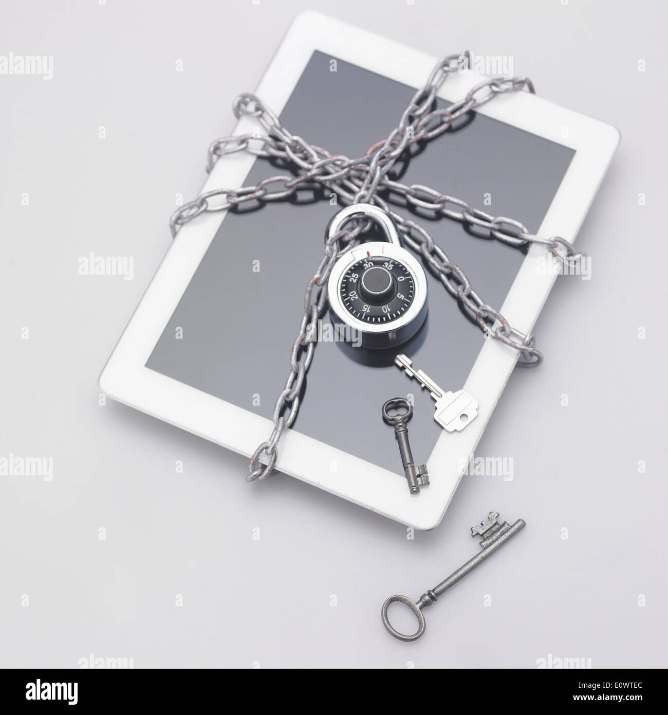 a tablet locked with chains and a lock Stock Photo - Alamy