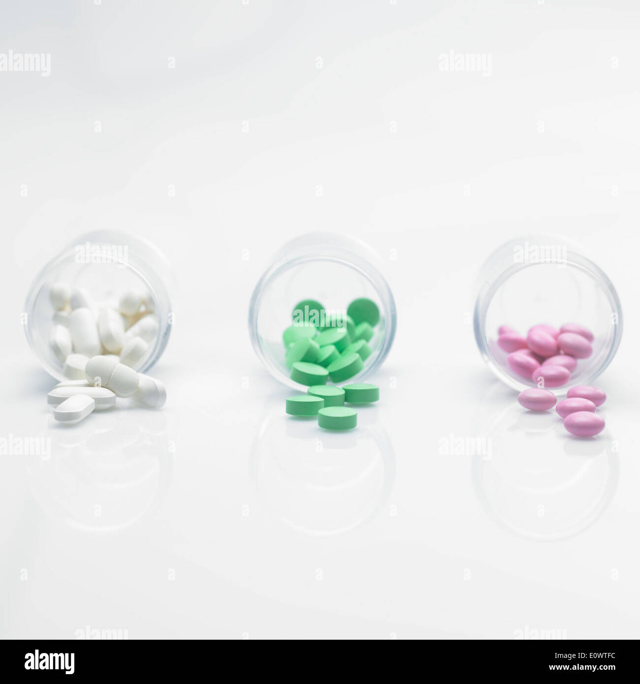 different color pills coming out from jars Stock Photo - Alamy