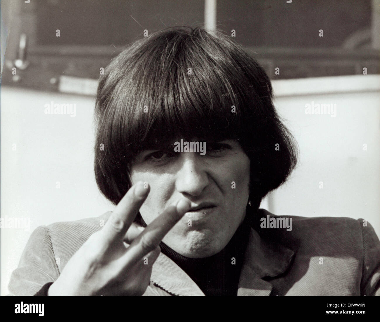 Beatle George Harrison showing the peace sign while filming at ...