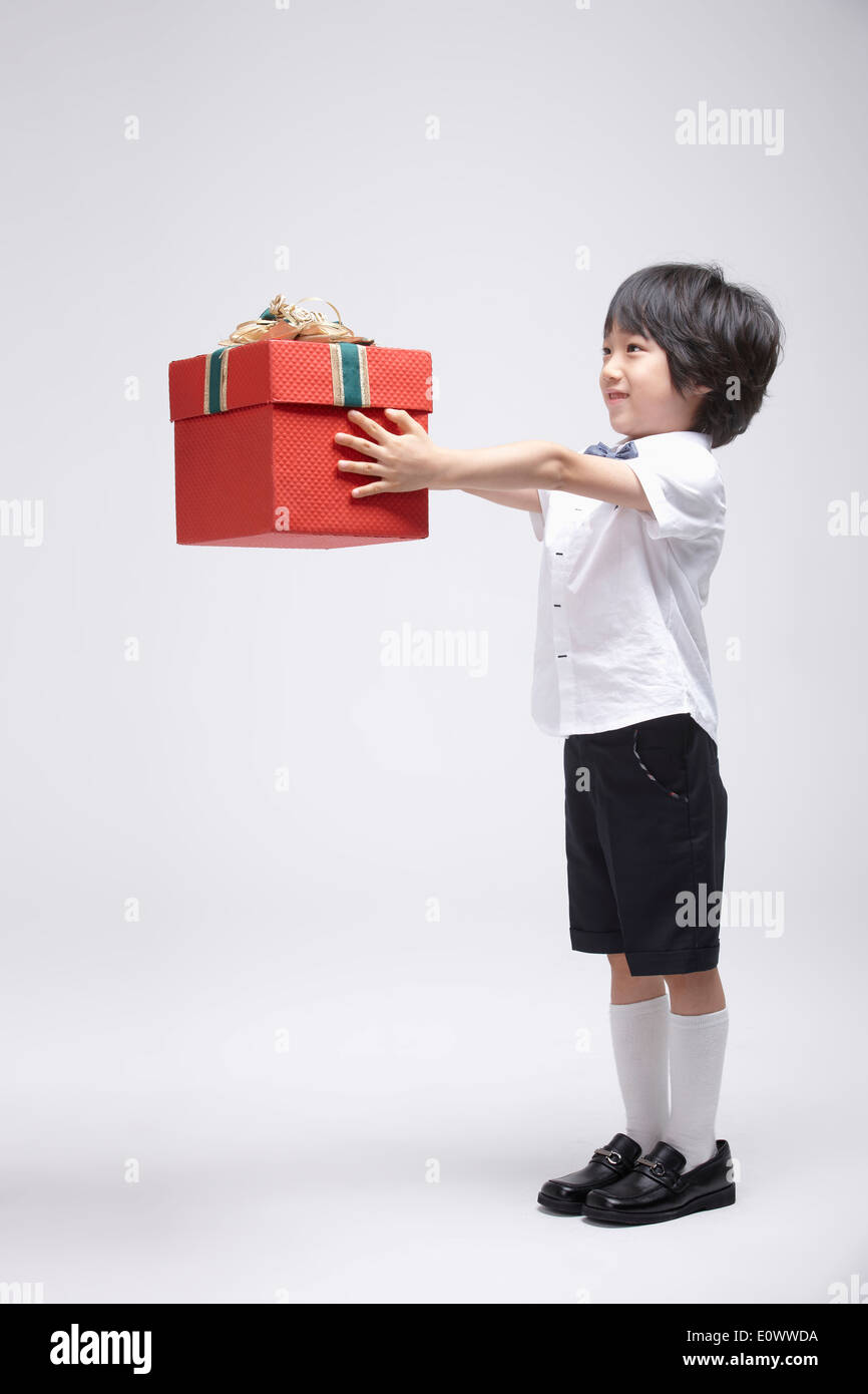 a boy holding a box Stock Photo - Alamy