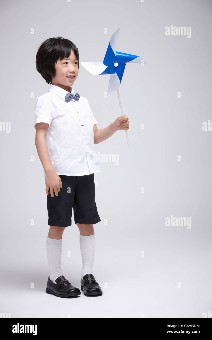 a boy holding a toy windmill Stock Photo - Alamy