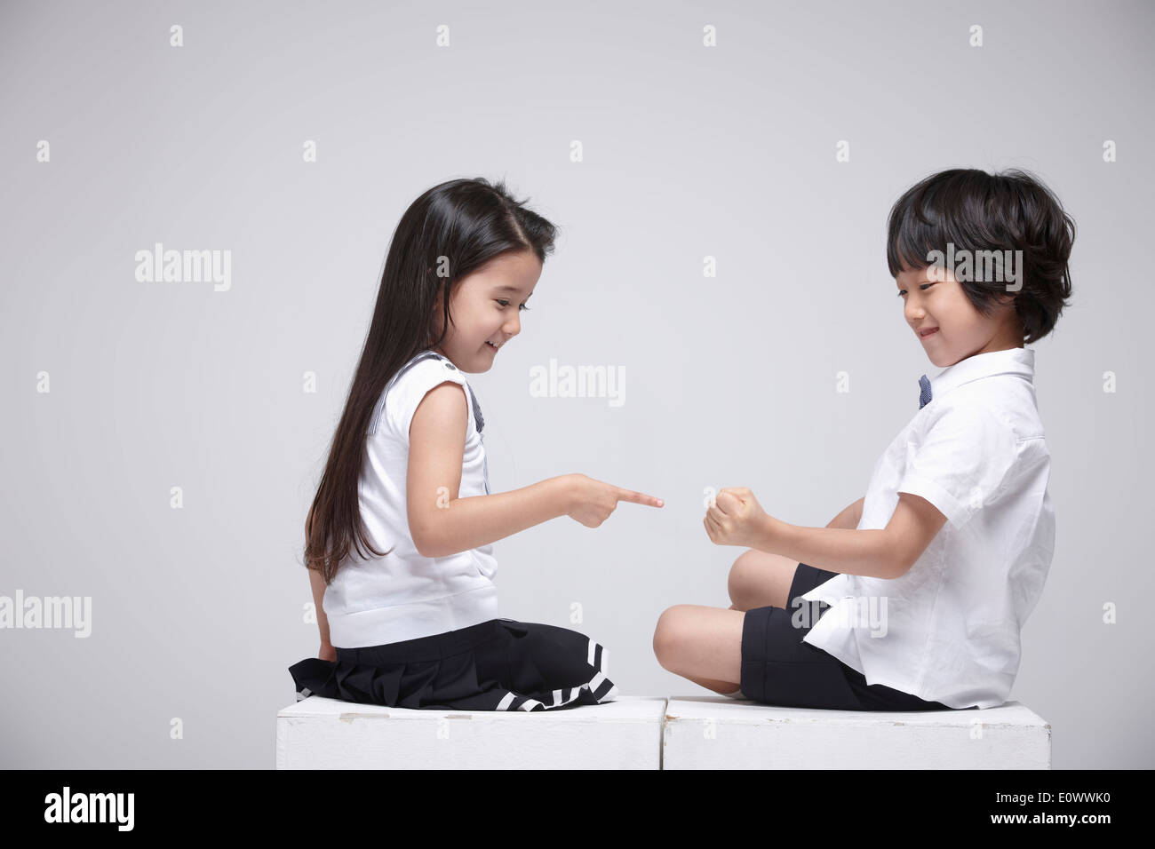 a boy and a girl sitting next to each other Stock Photo - Alamy