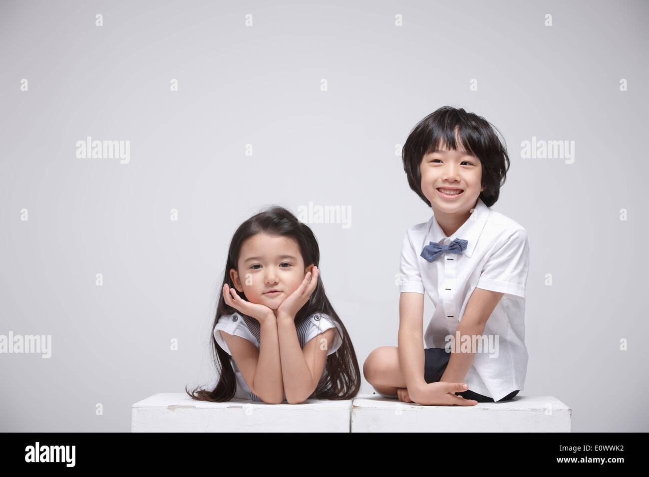 a boy and a girl sitting next to each other Stock Photo - Alamy