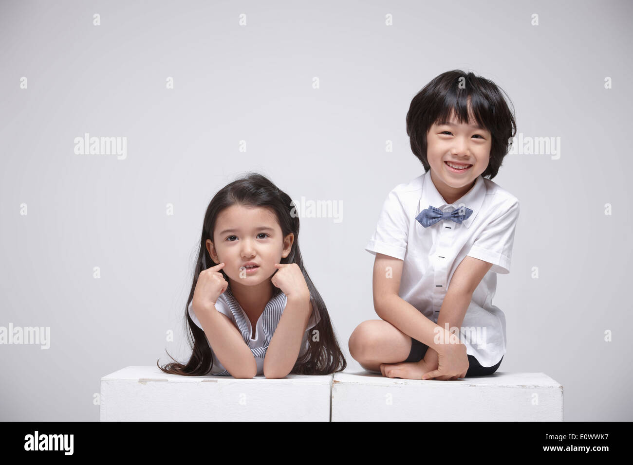 a boy and a girl sitting next to each other Stock Photo - Alamy