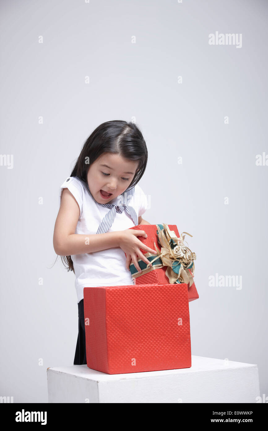 a girl opening a box Stock Photo - Alamy