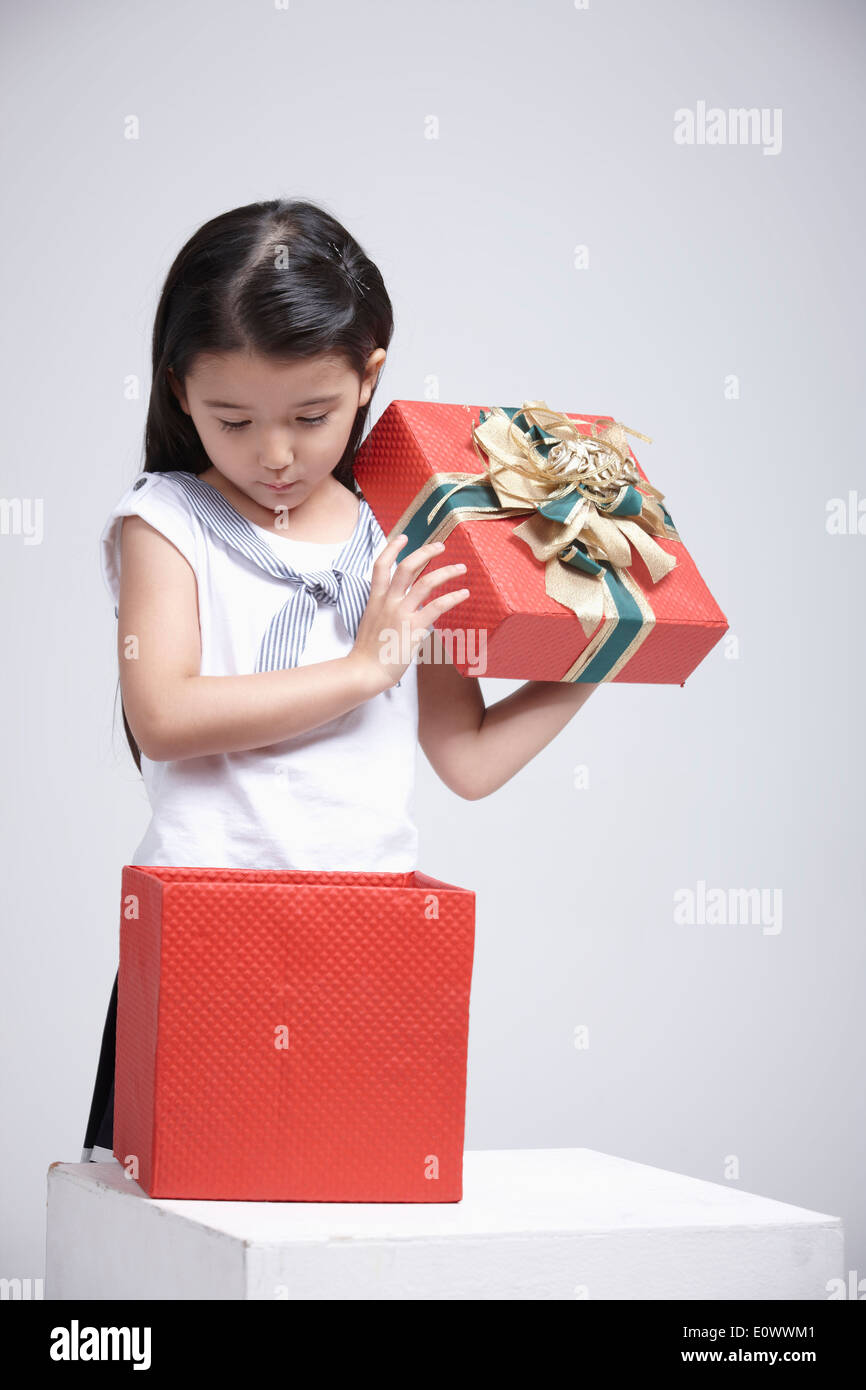 a girl opening a box Stock Photo - Alamy