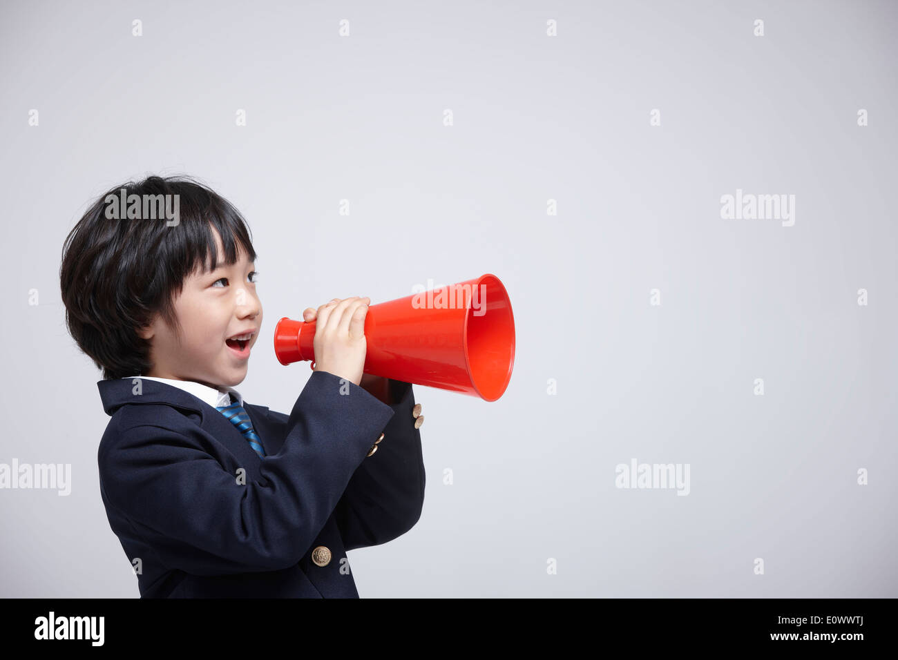 cute child using a megaphone in a classroom Stock Photo - Alamy
