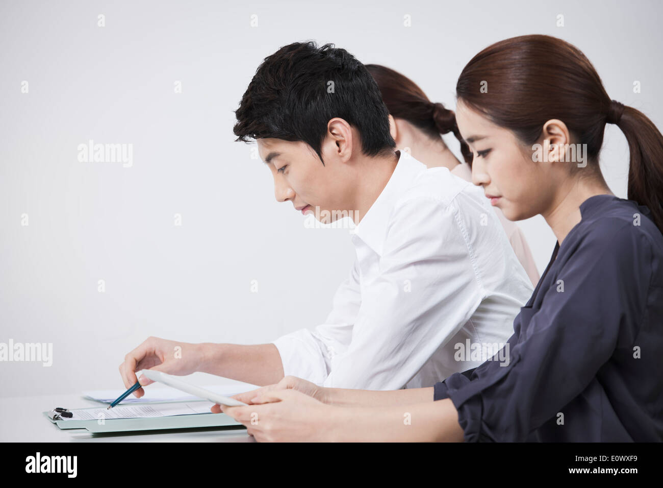 people sitting and reading papers Stock Photo - Alamy