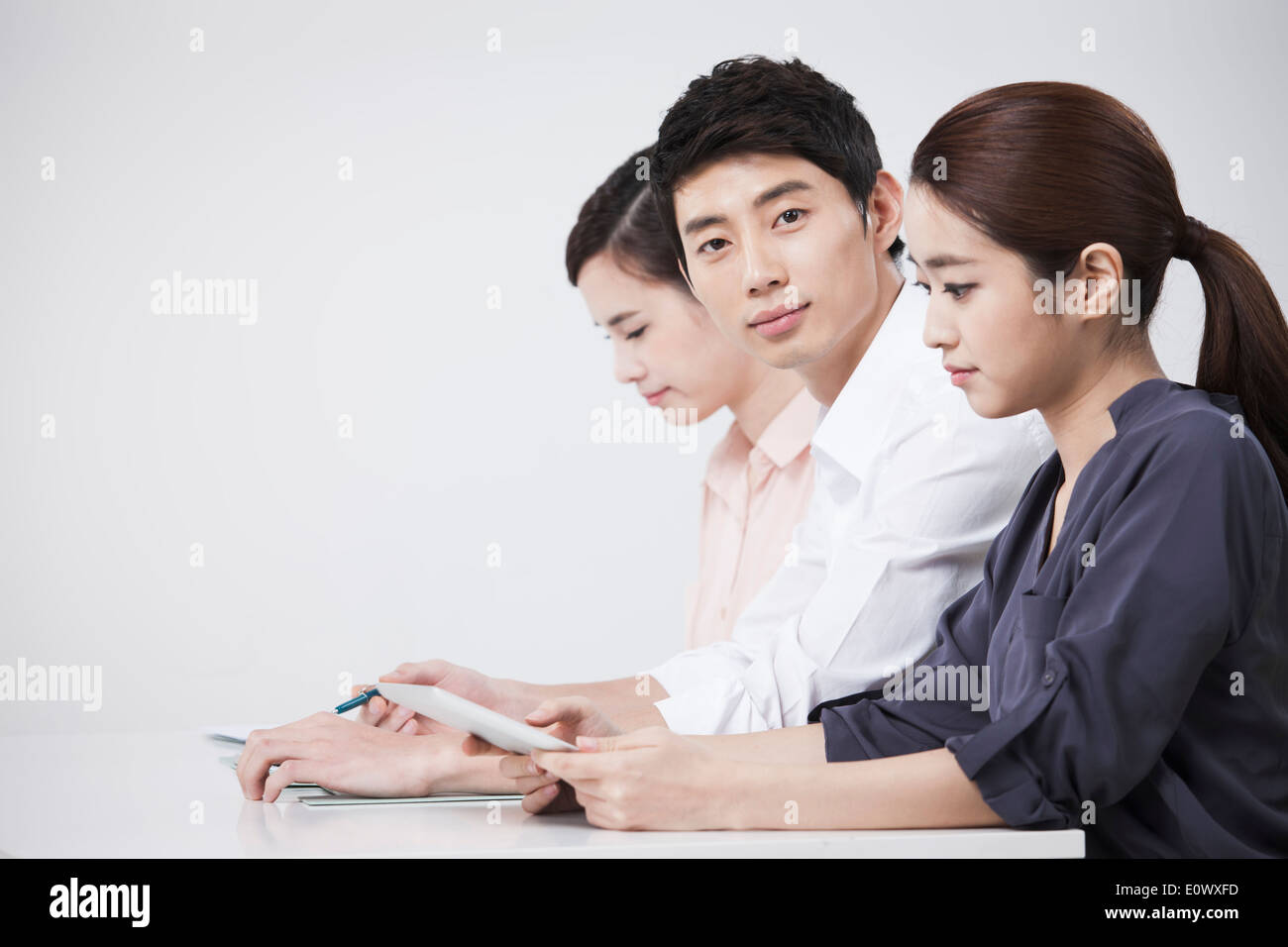 people sitting and reading papers Stock Photo - Alamy