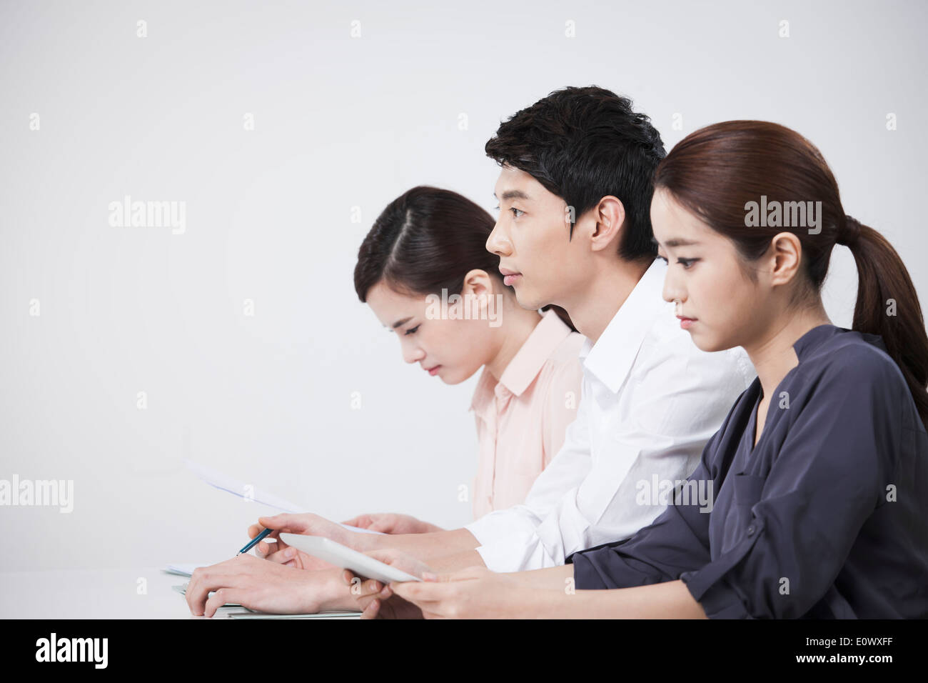 people sitting and reading papers Stock Photo - Alamy