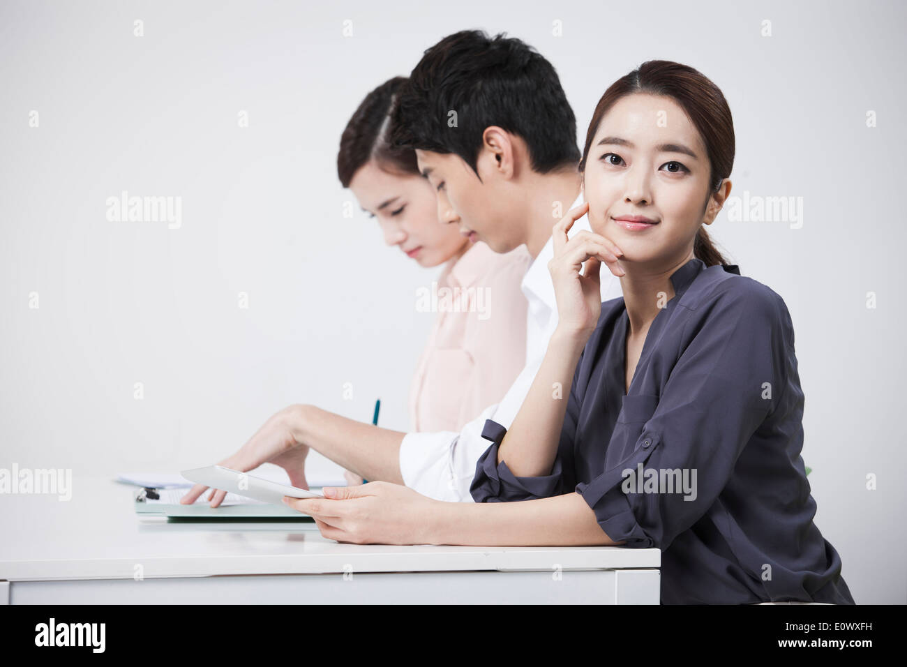 people sitting and reading papers Stock Photo - Alamy