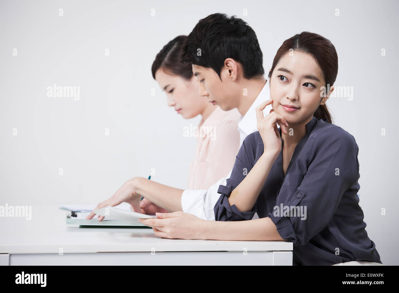 people sitting and reading papers Stock Photo - Alamy