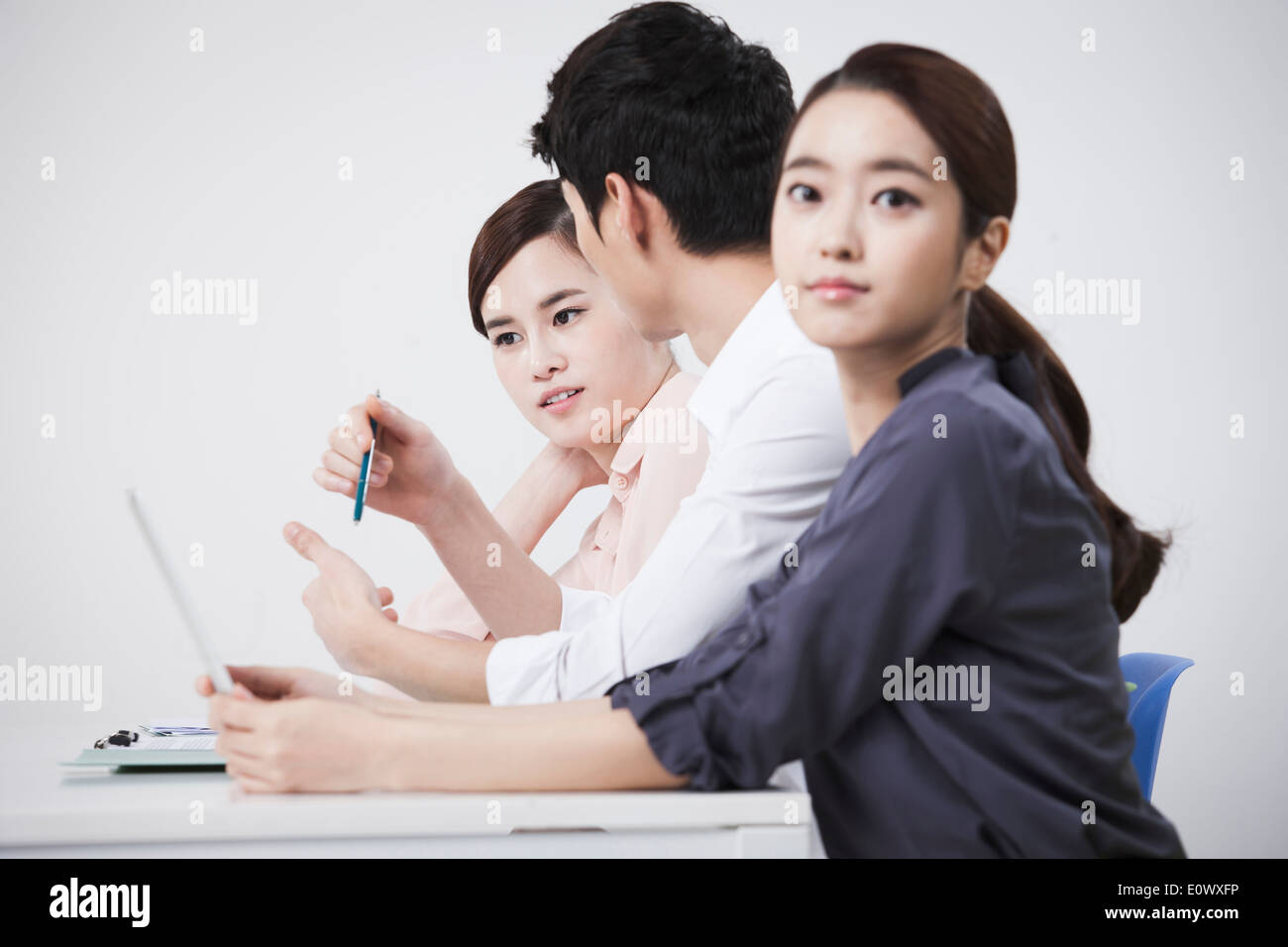 people sitting and reading papers Stock Photo - Alamy