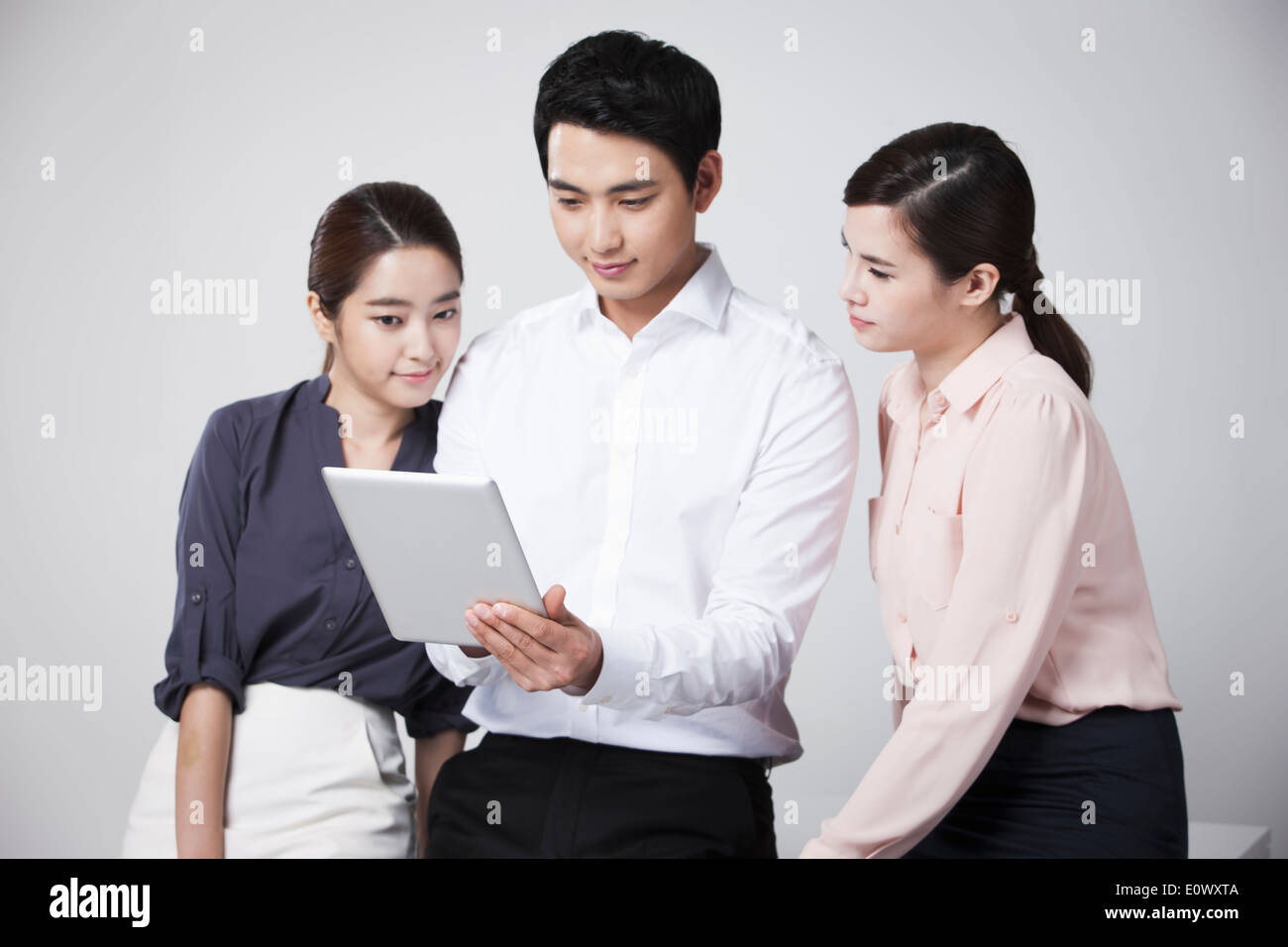 business people reading from a tablet Stock Photo - Alamy