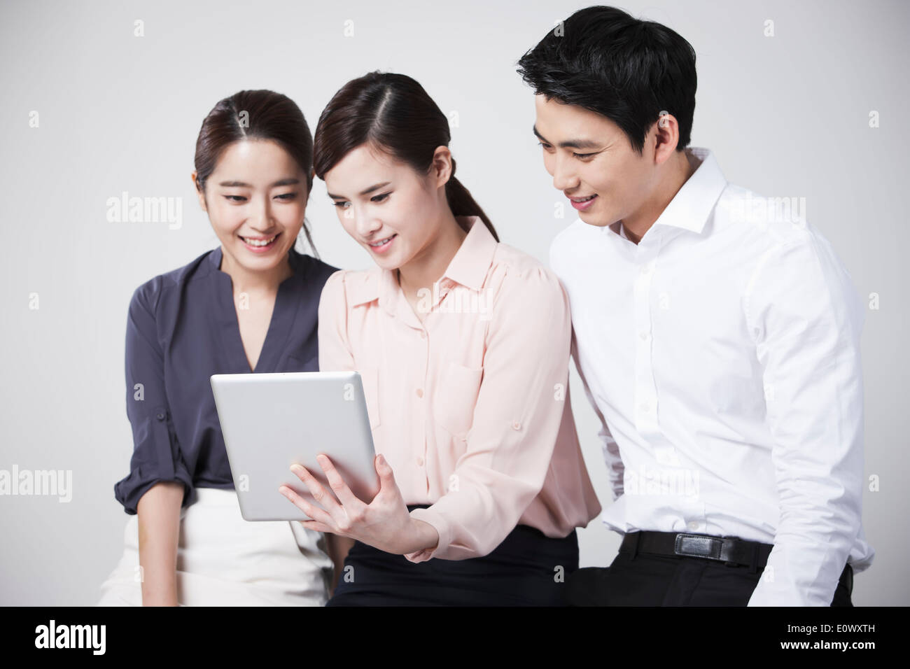 business people reading from a tablet Stock Photo - Alamy