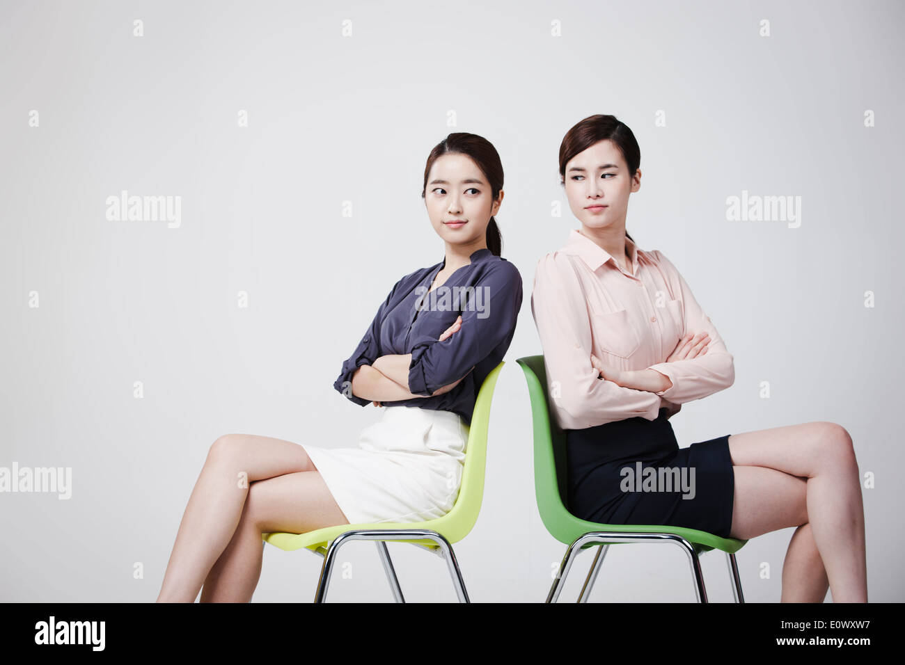 two women sitting on a chair Stock Photo - Alamy