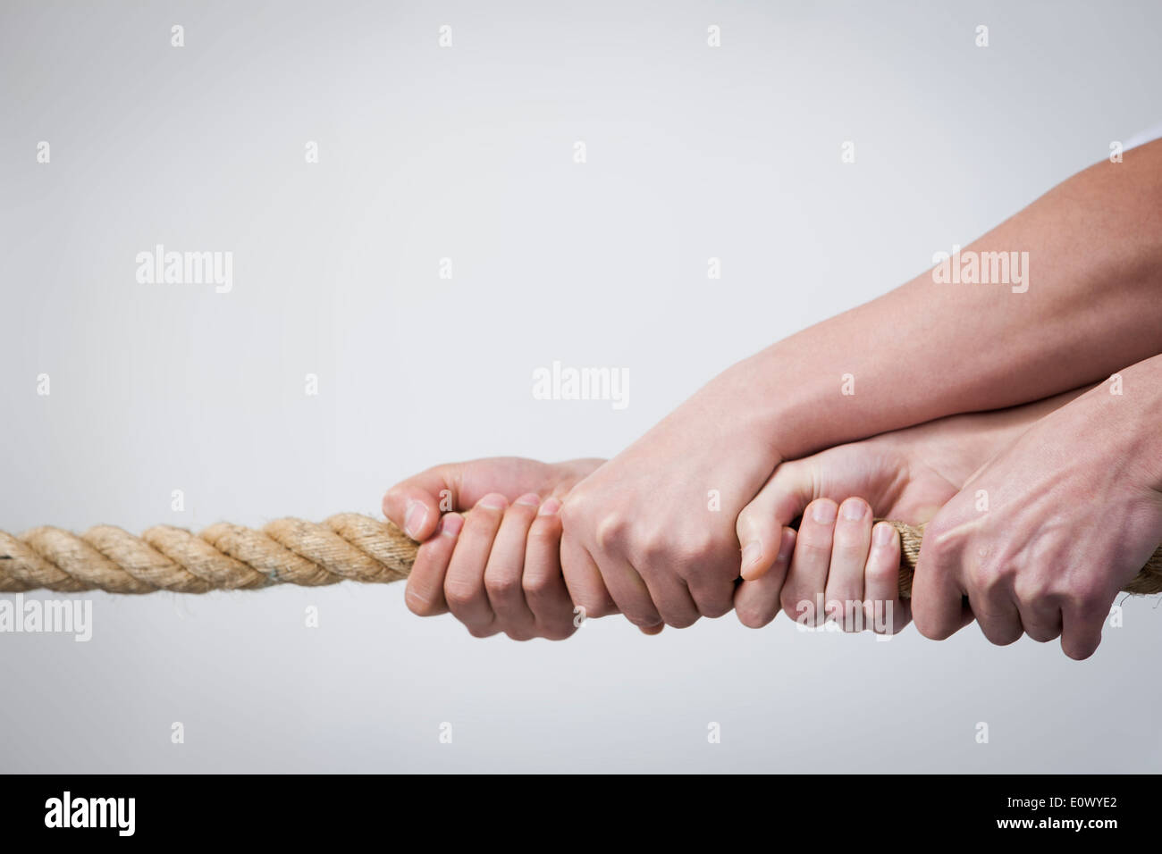 people pulling a rope Stock Photo - Alamy