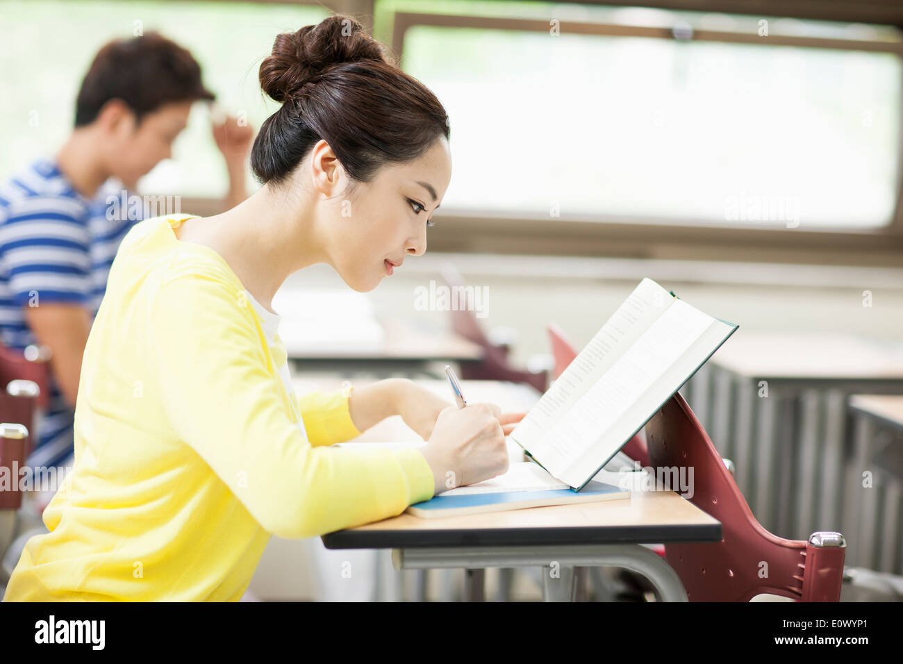 a woman studying in class Stock Photo - Alamy