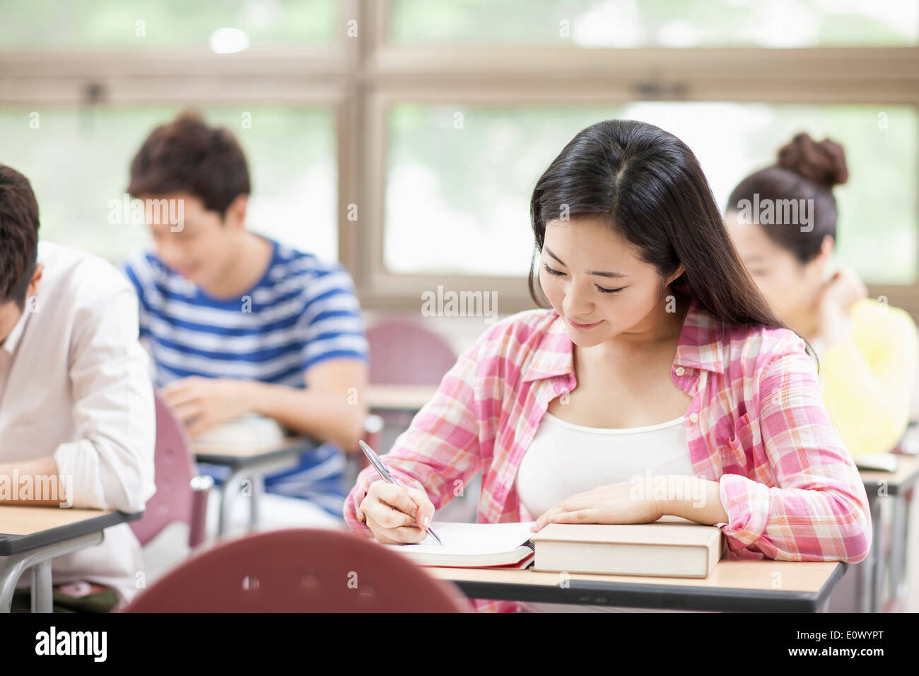 a woman studying in class Stock Photo - Alamy
