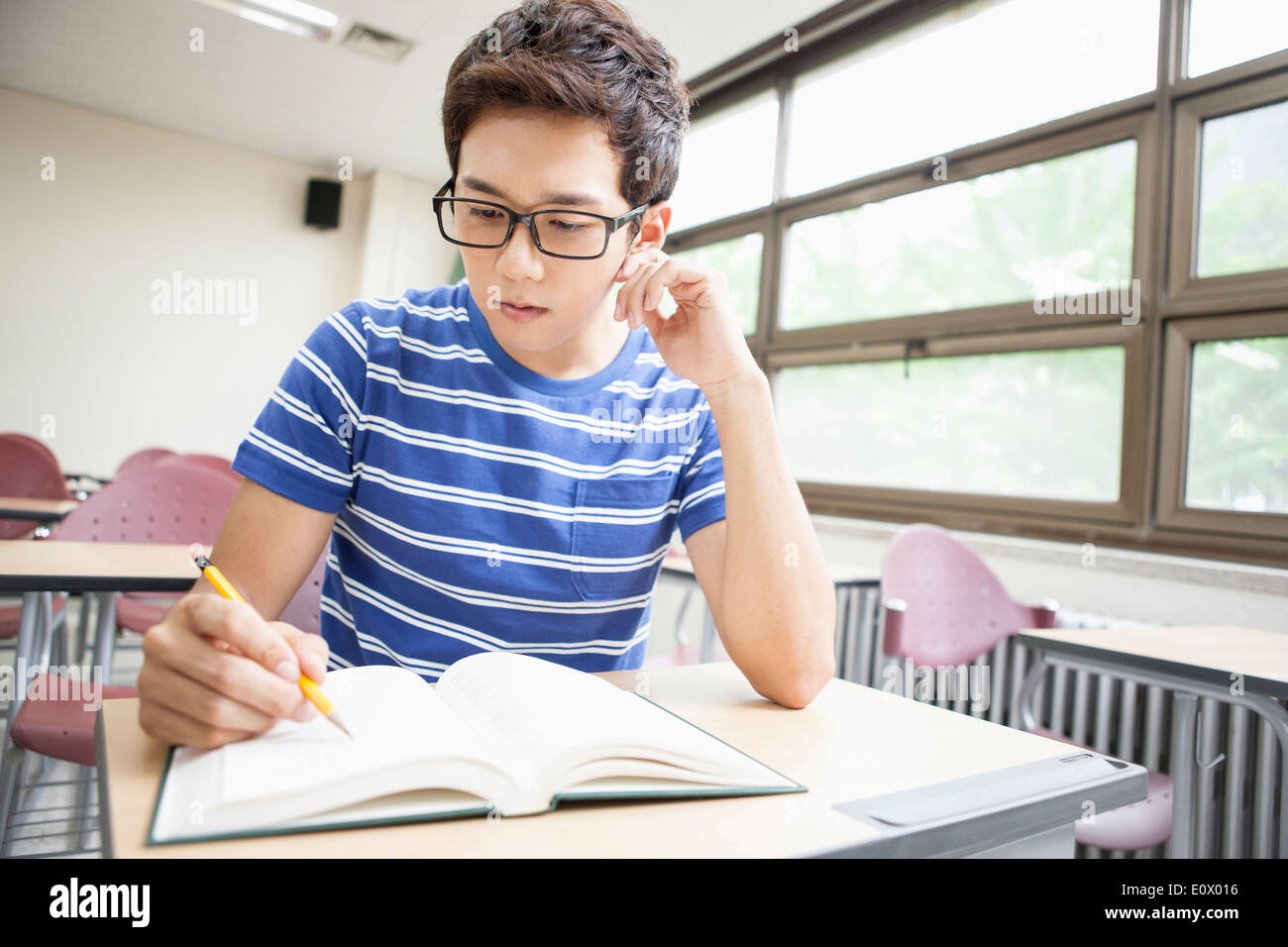 a man studying in class Stock Photo - Alamy