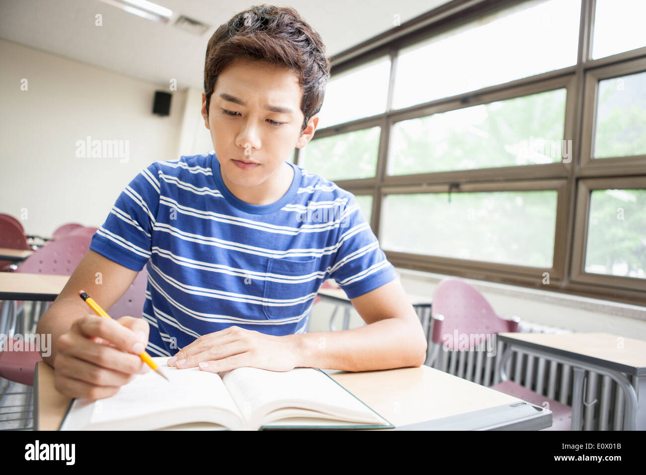 a man studying in class Stock Photo - Alamy