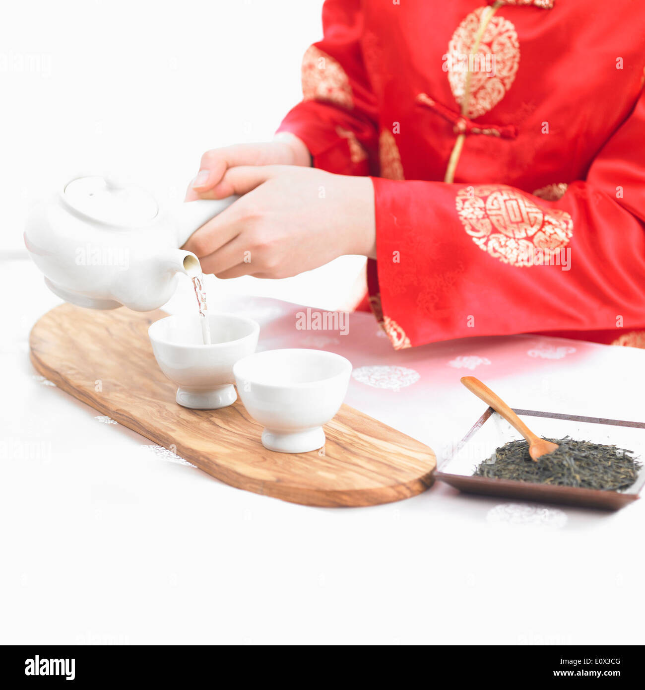 a woman with traditional clothes pouring a cup of tea Stock Photo - Alamy