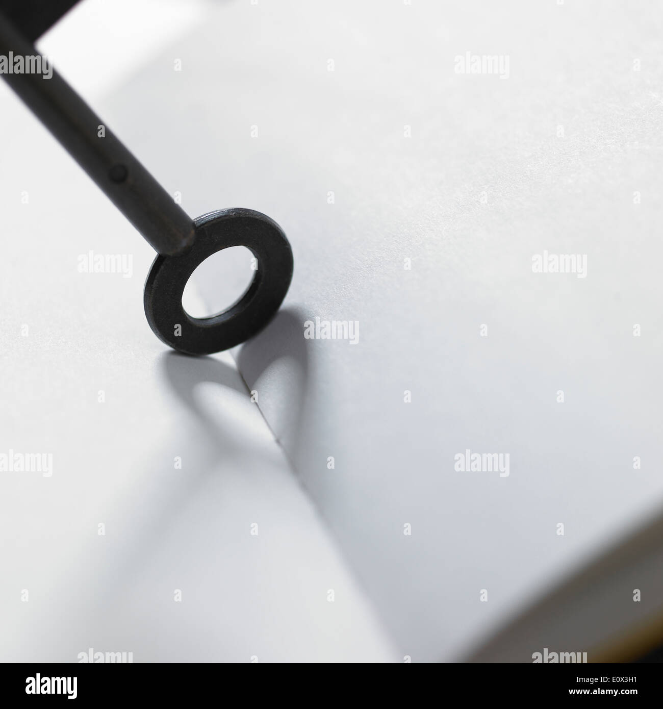 a key on top of an opened book Stock Photo - Alamy