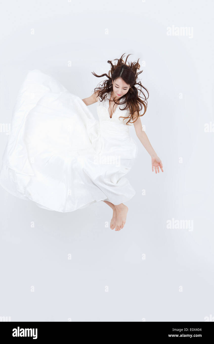 a woman in white floating in the air Stock Photo - Alamy