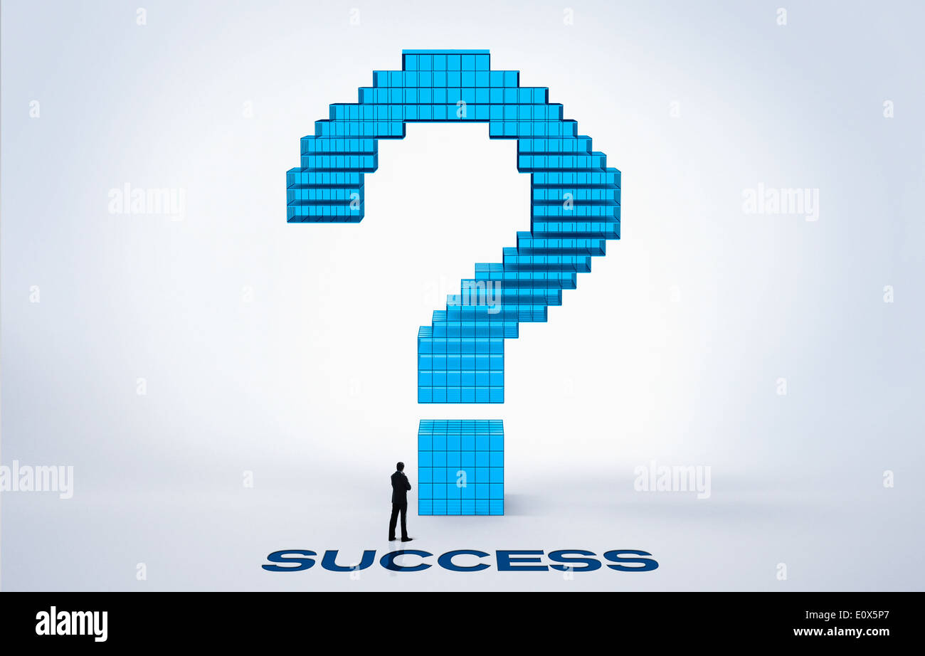 a business man standing next to a question mark Stock Photo - Alamy