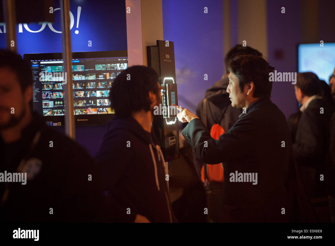 Manhattan, New York, USA. 19th May, 2014. Sano Shinchi of Tokyo looks over the Yahoo! booth at ...