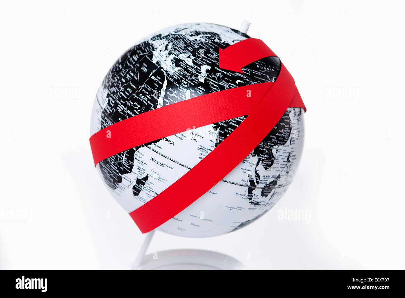 the globe wrapped in a red arrow Stock Photo - Alamy