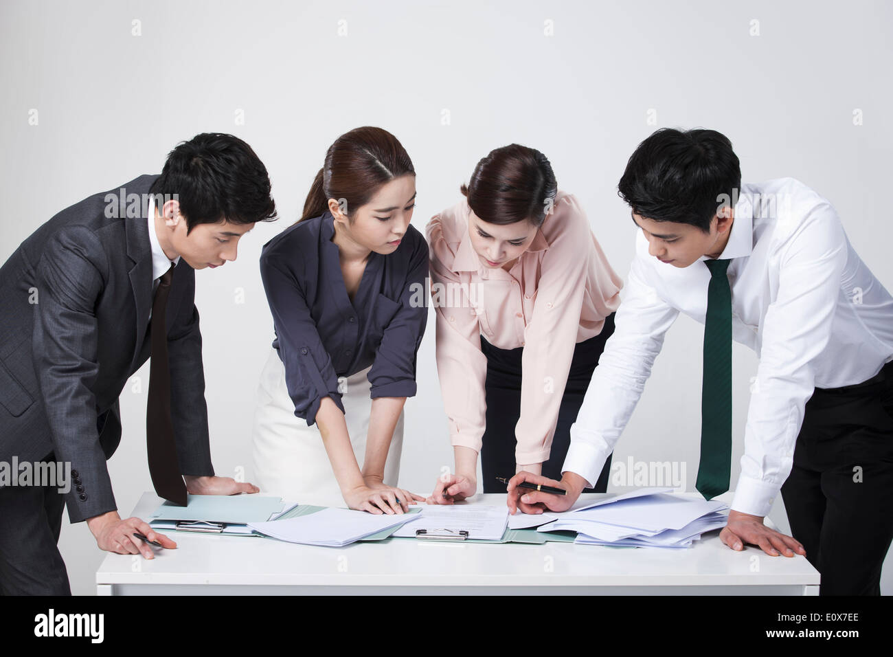 two business women and two business men working together Stock Photo ...