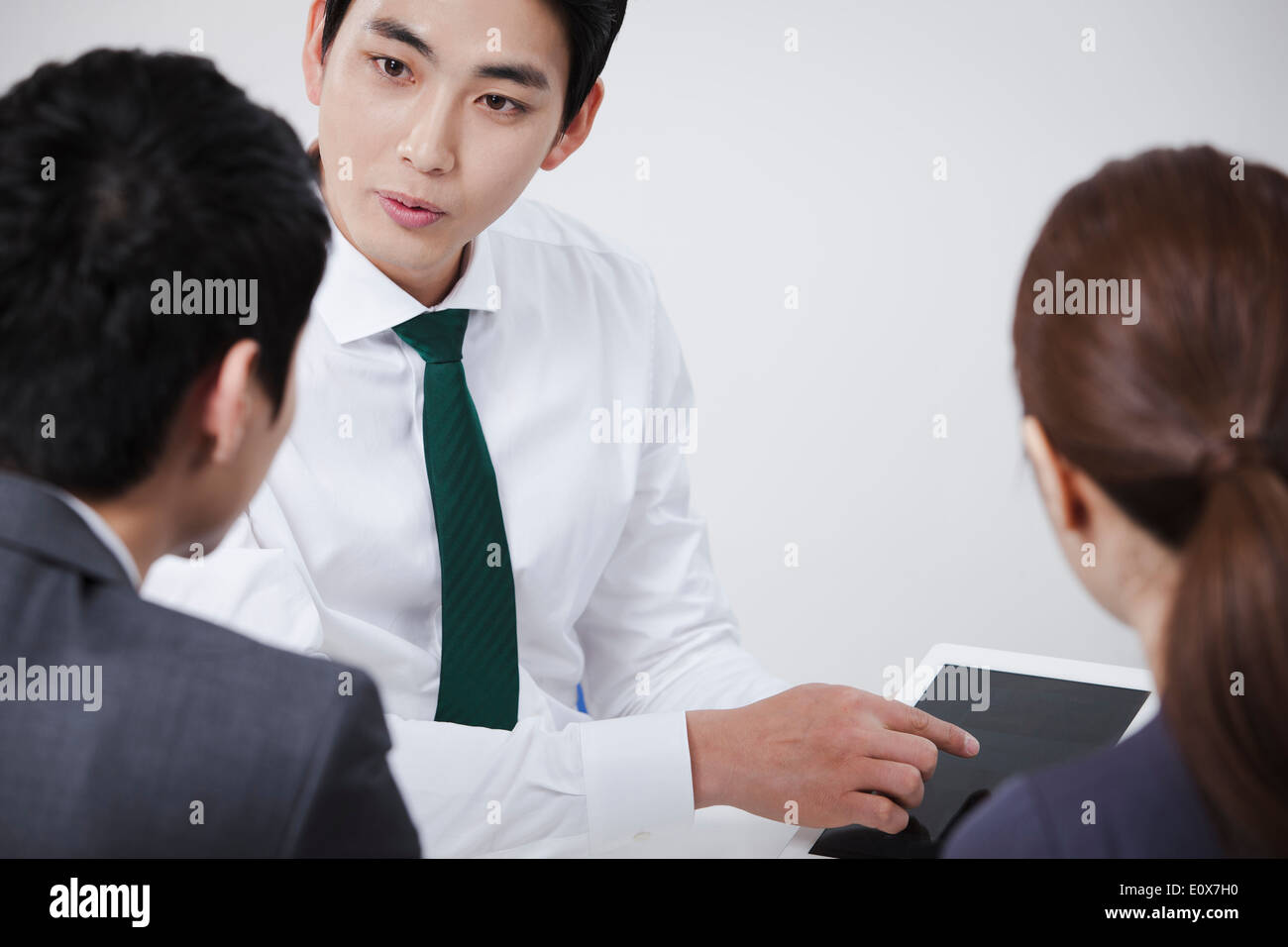 a business man showing tablet to other workers Stock Photo - Alamy