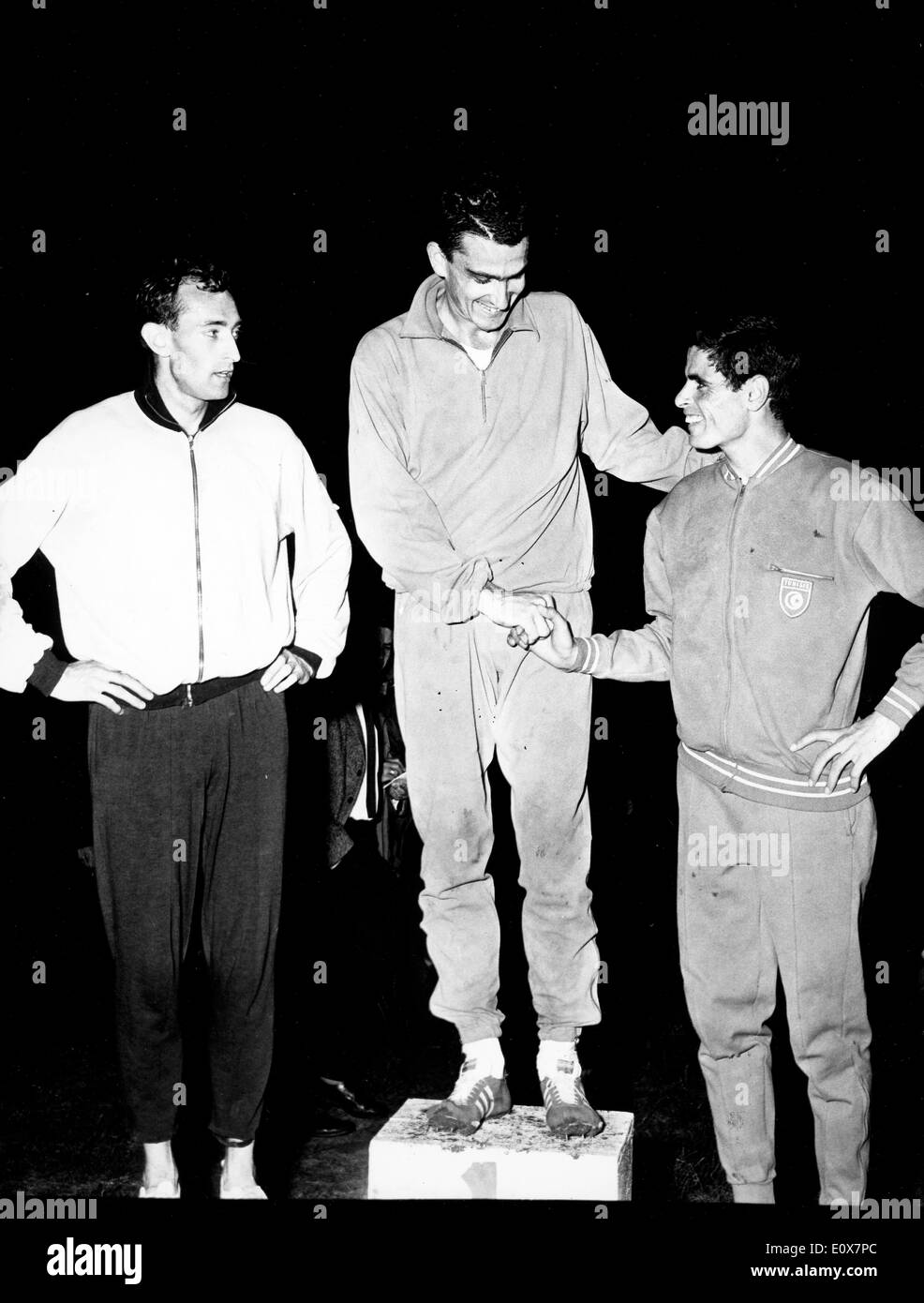 RON CLARKE, center, after winning a 5000m race at Charltey Stadium ...