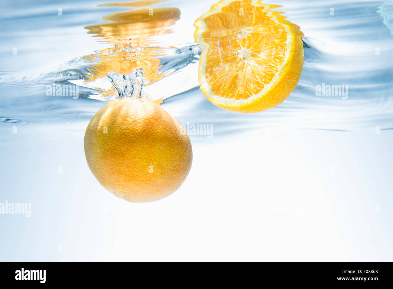 Orange halves falling water hi-res stock photography and images - Alamy