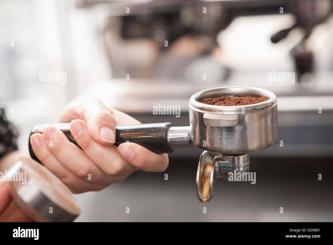 a person operating a espresso machine Stock Photo - Alamy