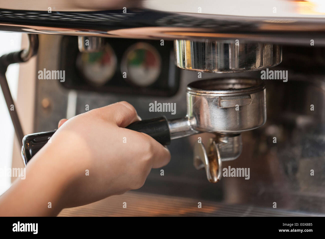 a person operating a espresso machine Stock Photo - Alamy
