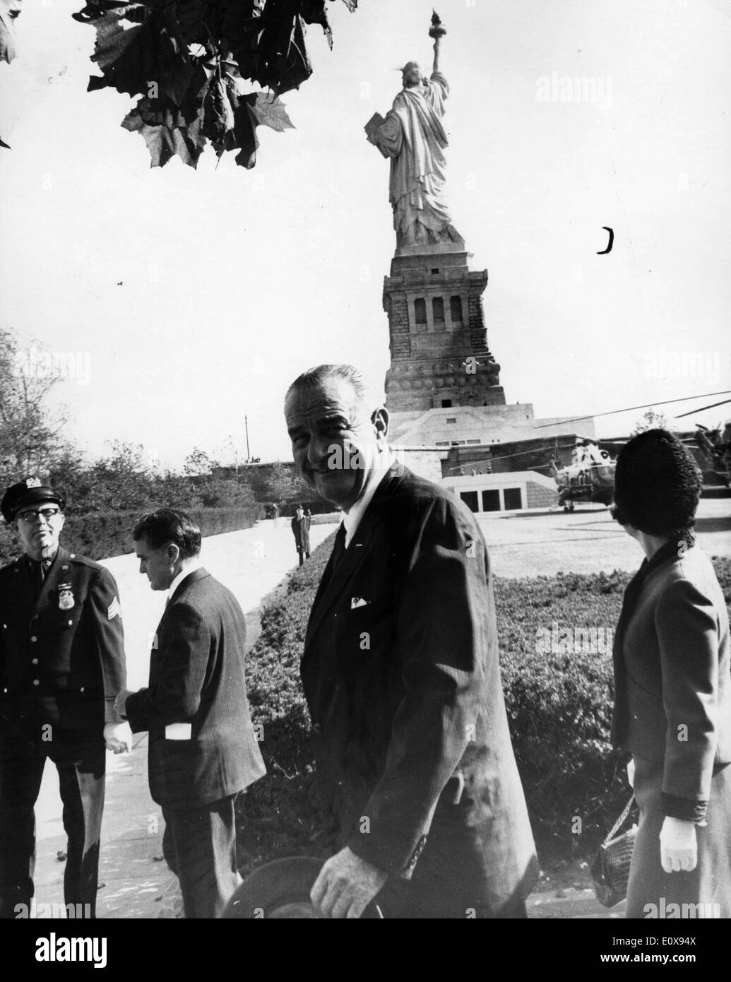 President Lyndon B. Johnson walks by the Statue of Liberty Stock Photo ...