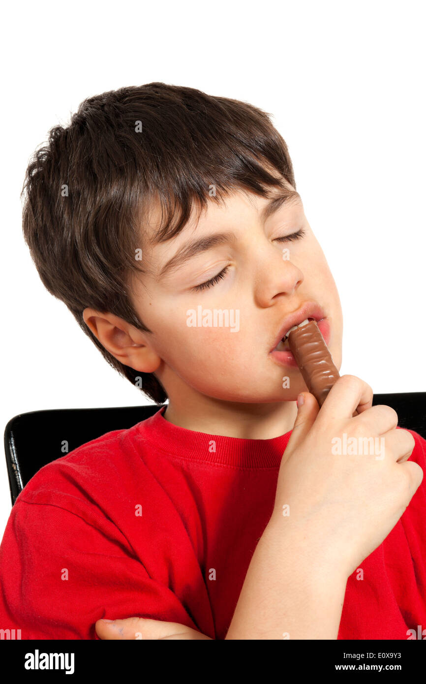 little boy eating a chocolate stick, isolated on white background Stock ...